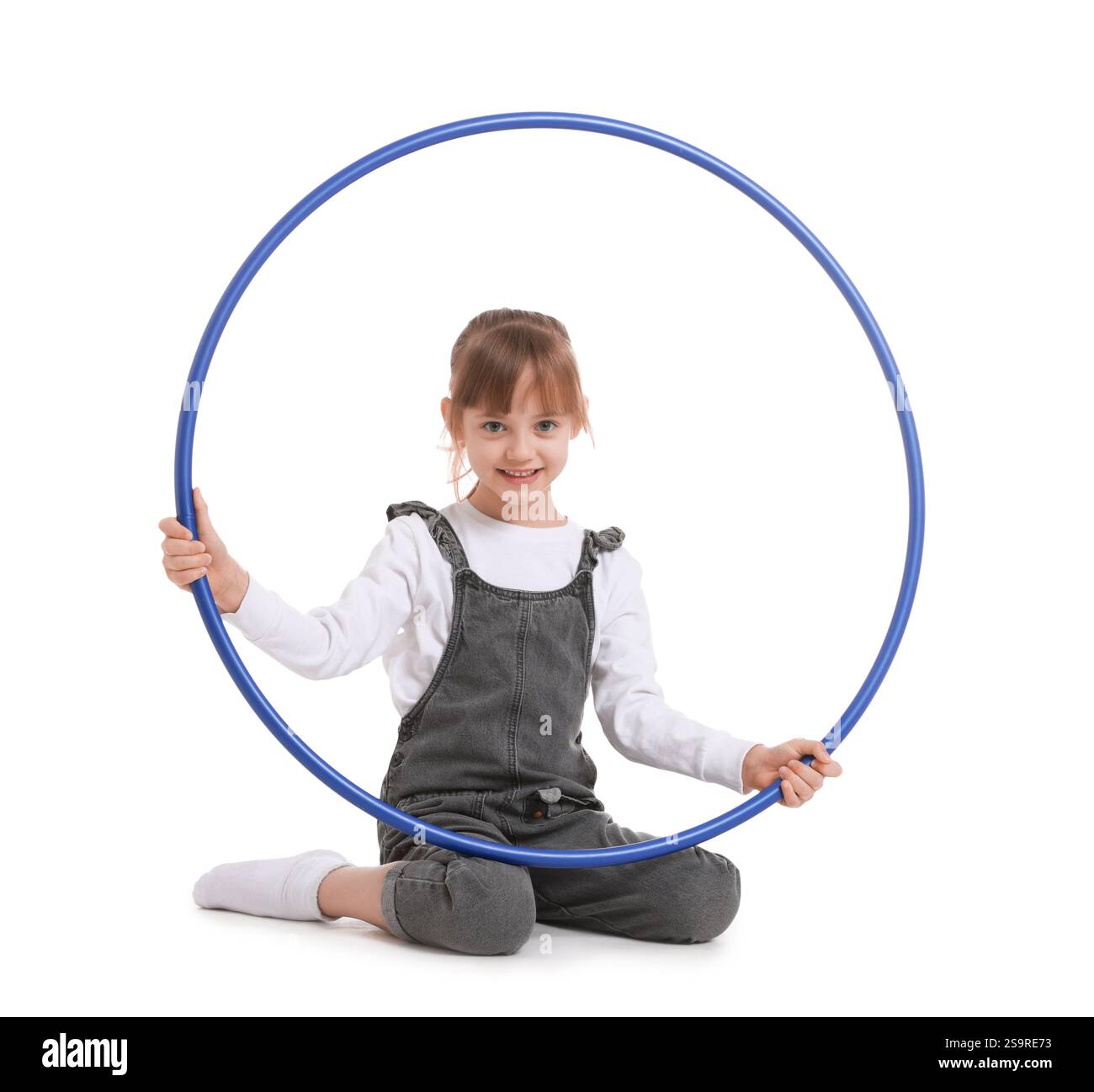 Cute little girl with hula hoop on white background Stock Photo - Alamy