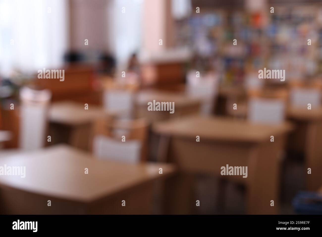 Desks and chairs in public library room, blurred view Stock Photo - Alamy