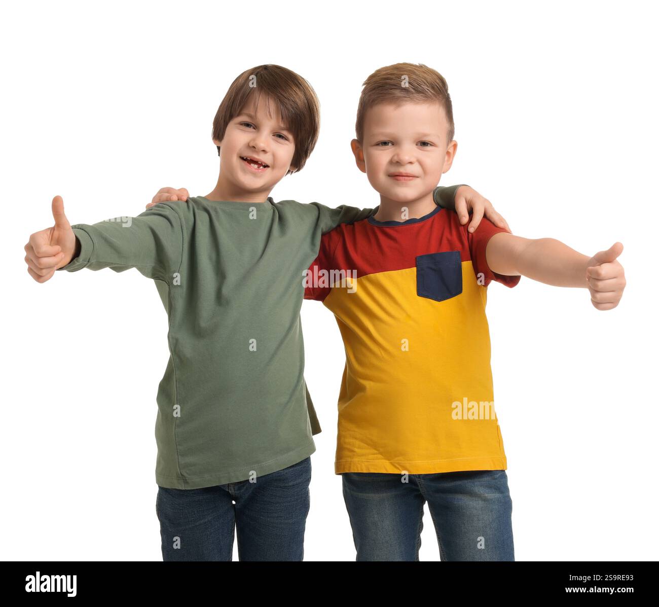 Cute brothers showing thumbs up on white background Stock Photo - Alamy