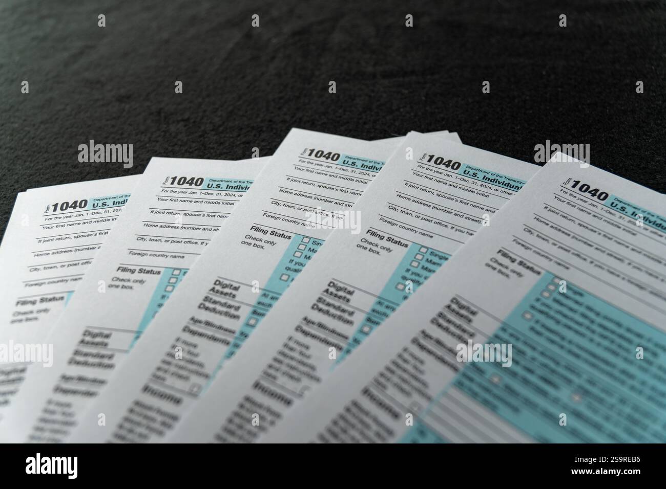 Federal income tax return preparation with 1040 form and calculator for ...