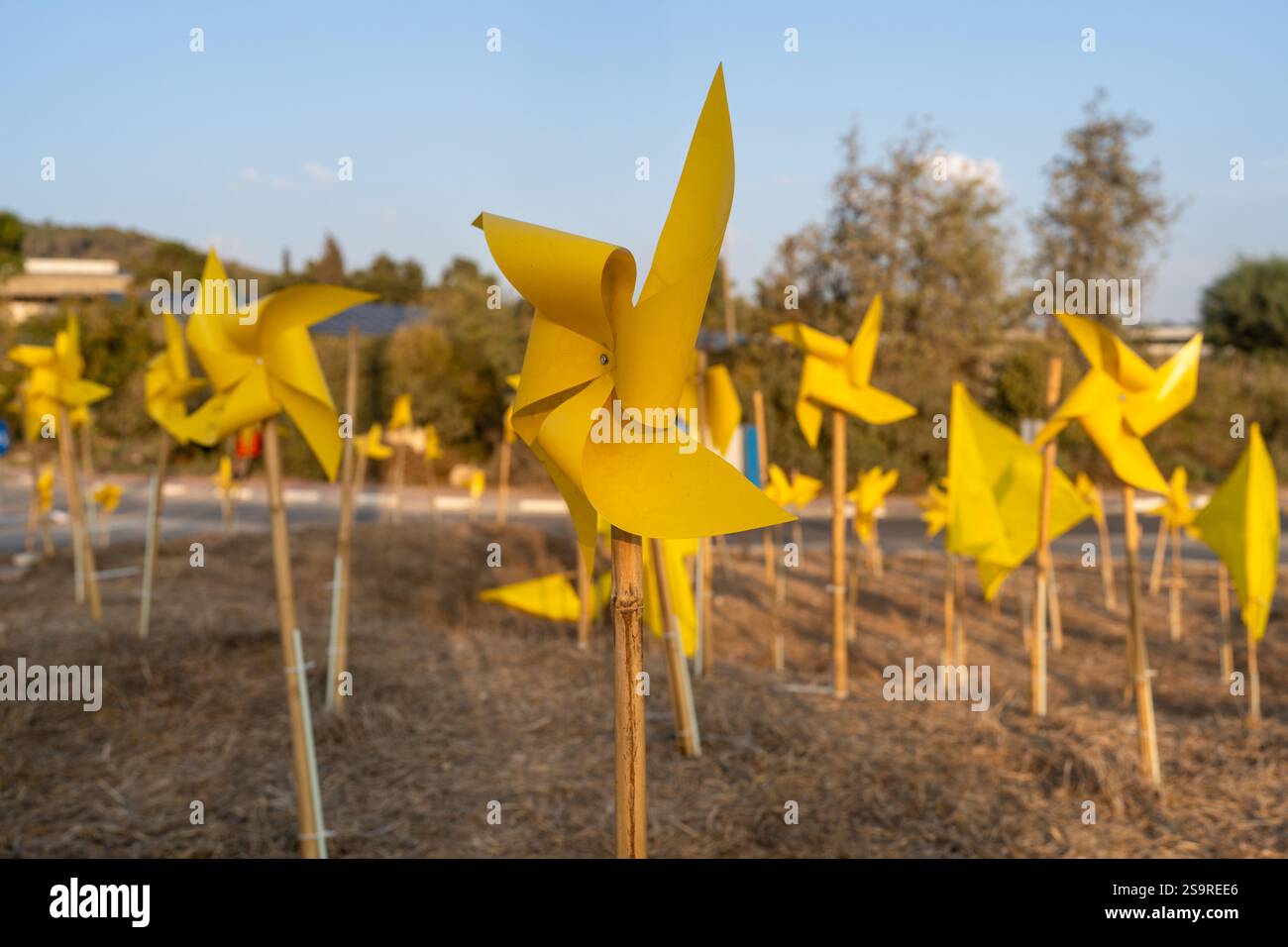 A field filled with yellow pinwheels serves as a poignant tribute to ...
