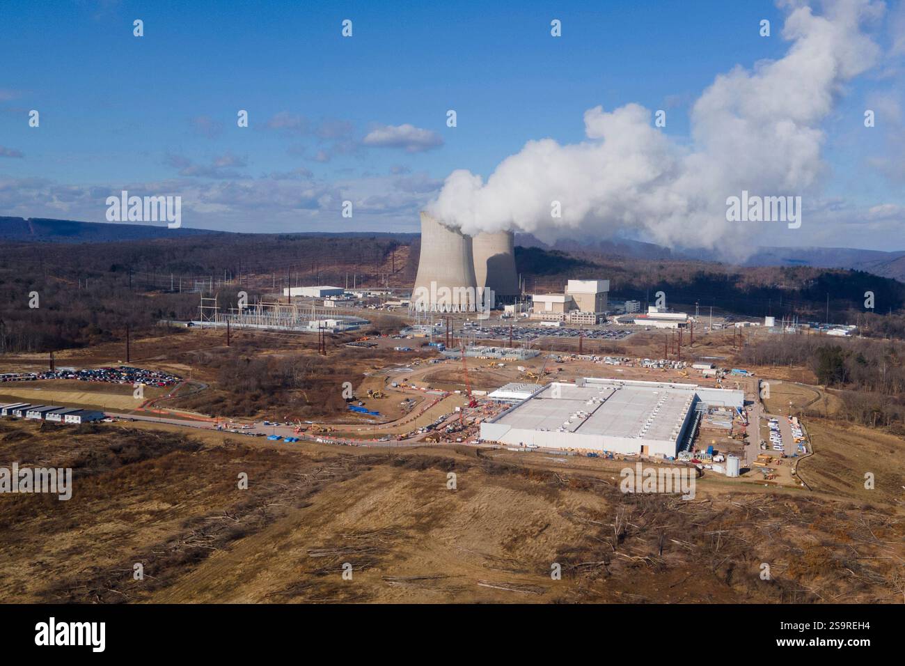 A data center owned by Amazon Web Services, front right, is under construction next to the ...