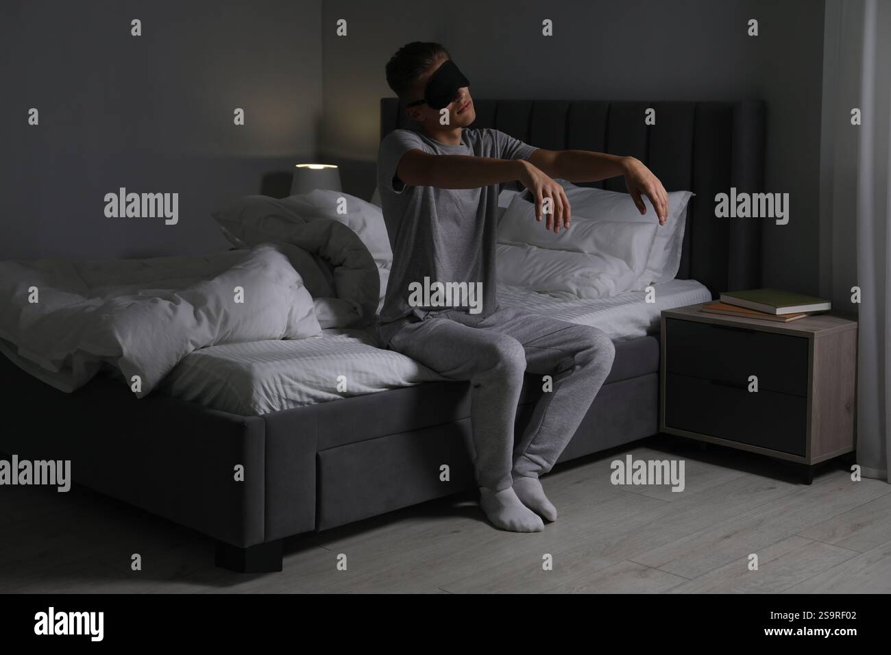 Young man suffering from sleepwalking on bed at home Stock Photo - Alamy