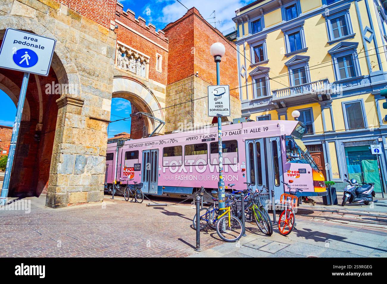 MILAN, ITALY - APRIL 8, 2022: The tram rides through medieval Porta ...