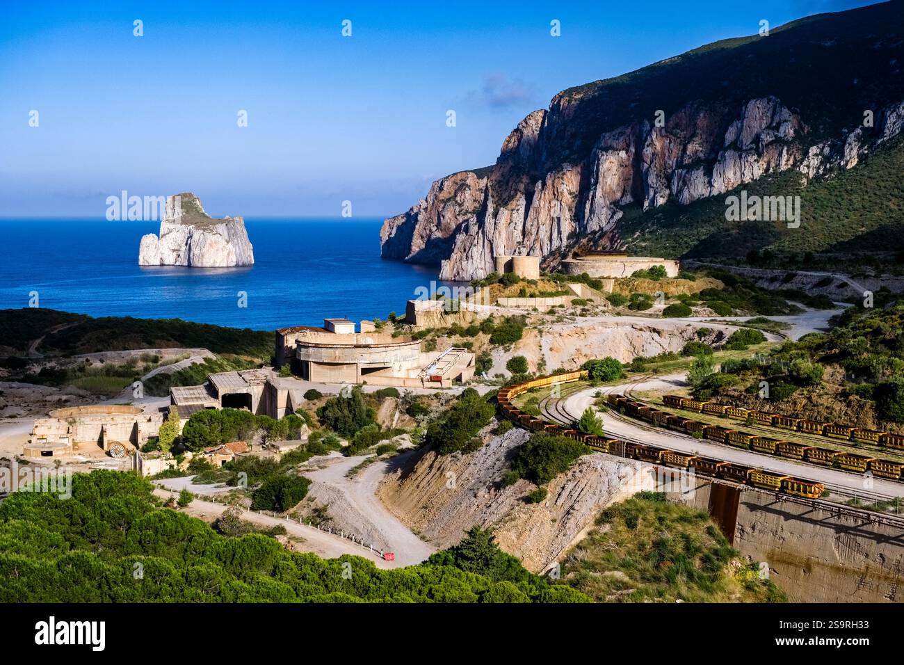 Aerial view of railway tracks, lorries and destroyed factory buildings ...