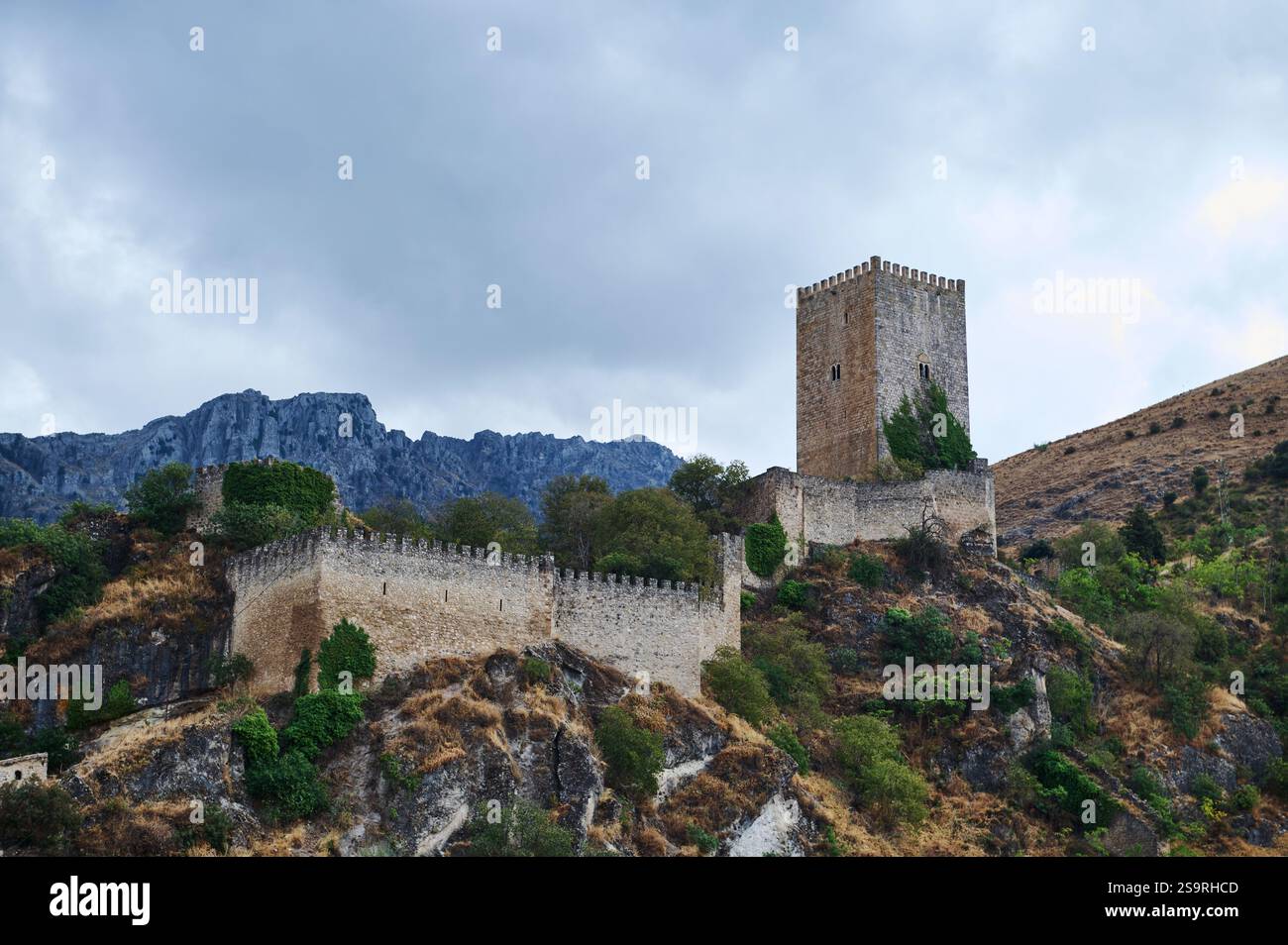 A scenic view of an ancient fortress on a hilly terrain covered with ...
