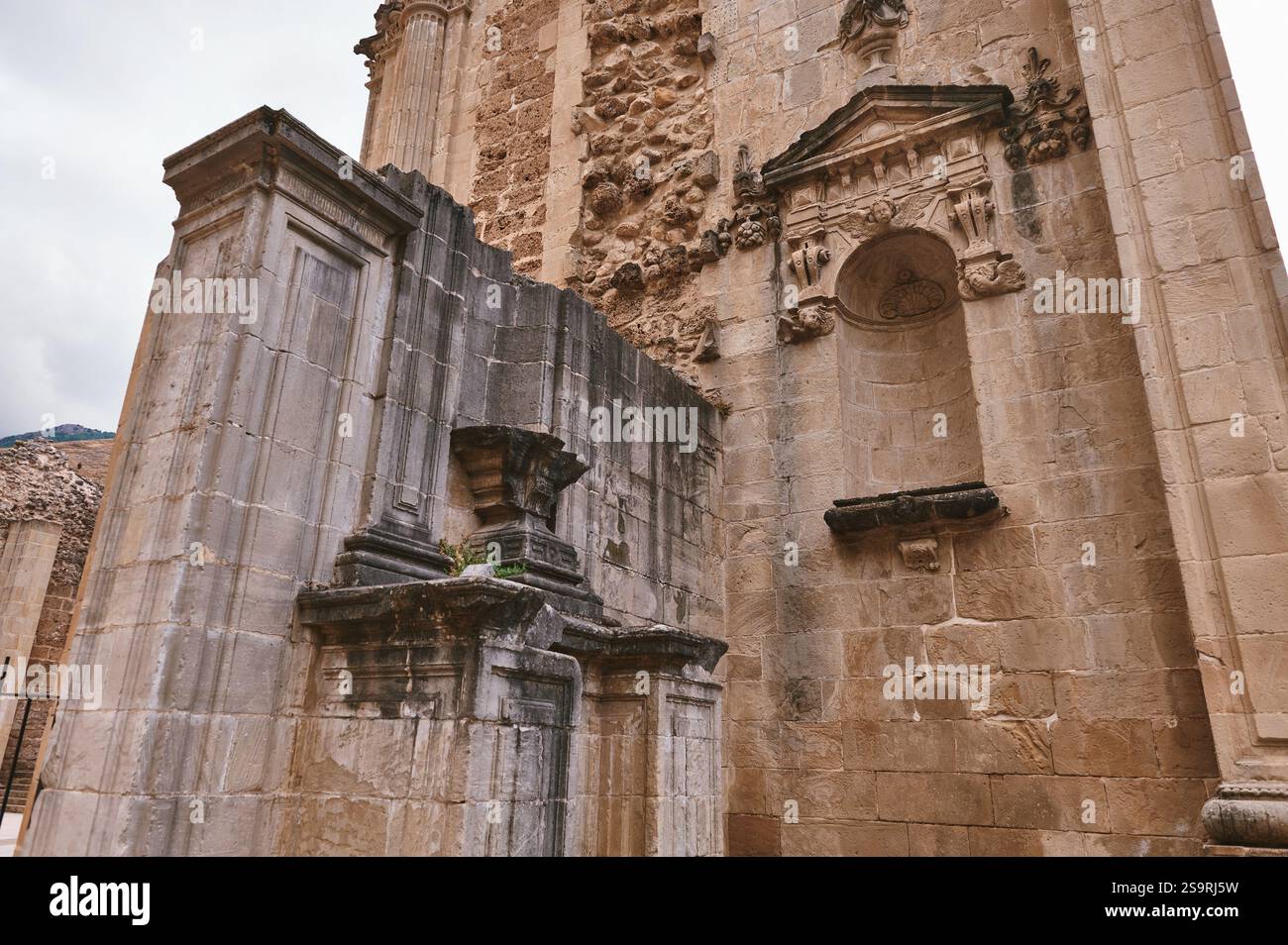 A historic stone facade features intricate architectural designs ...