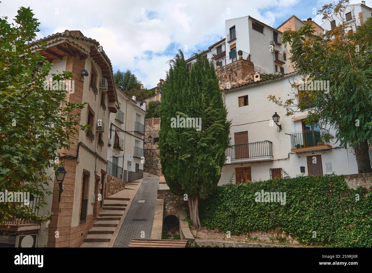 A picturesque view of a quaint street in a historic village, featuring ...