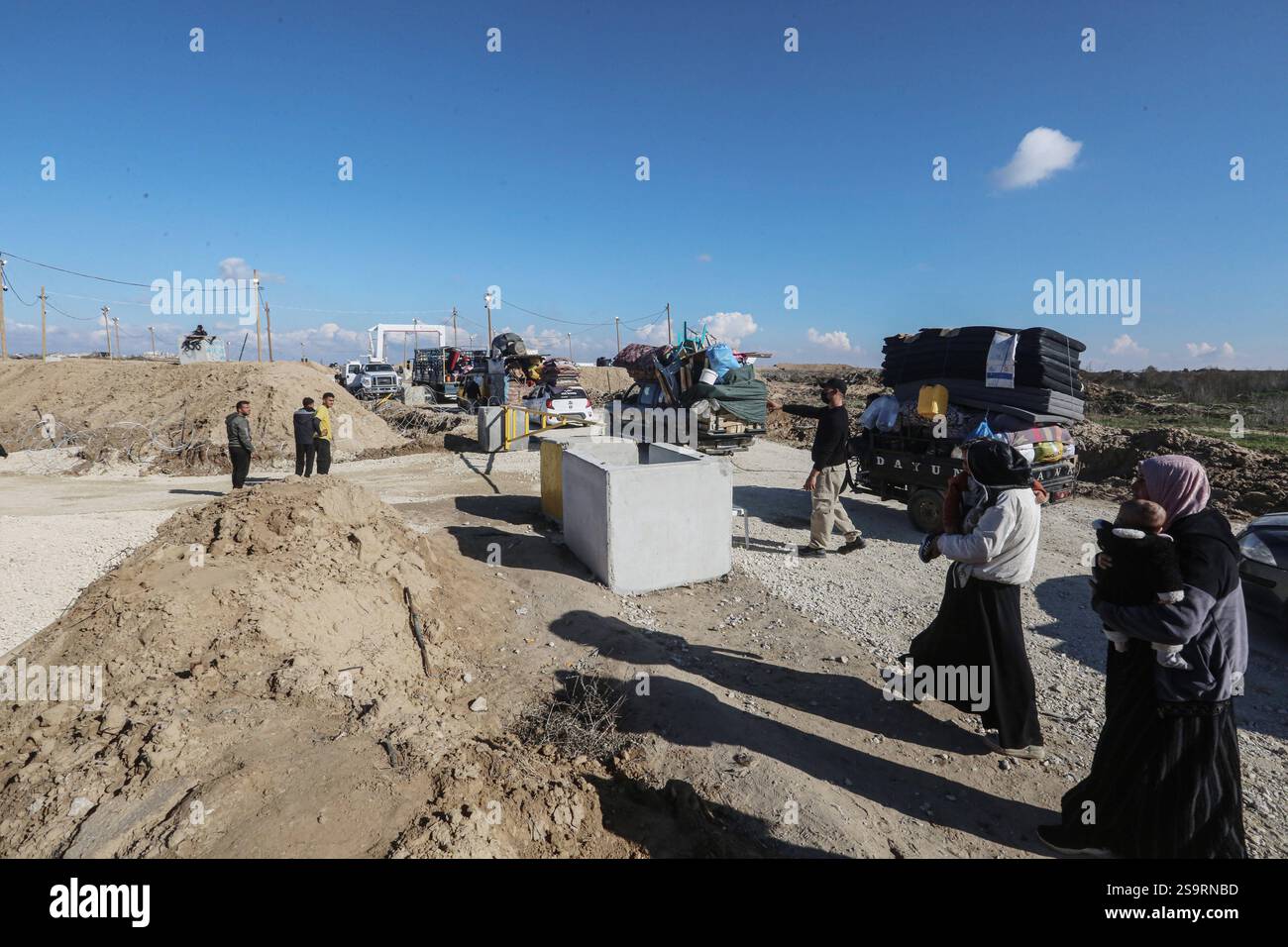 Displaced Gazans ride on the back of a vehicle with their belongings ...
