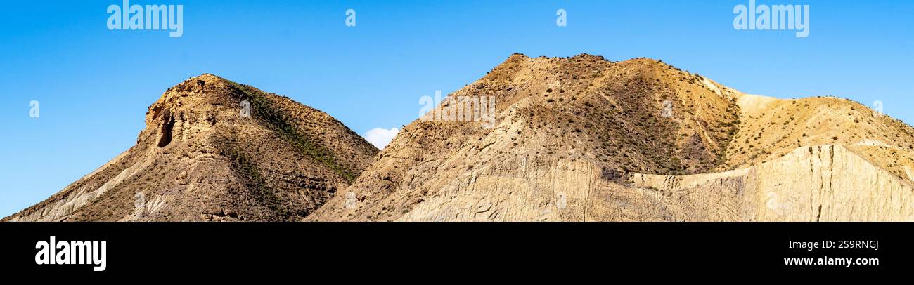A panoramic view of rugged mountains under a clear blue sky. The ...