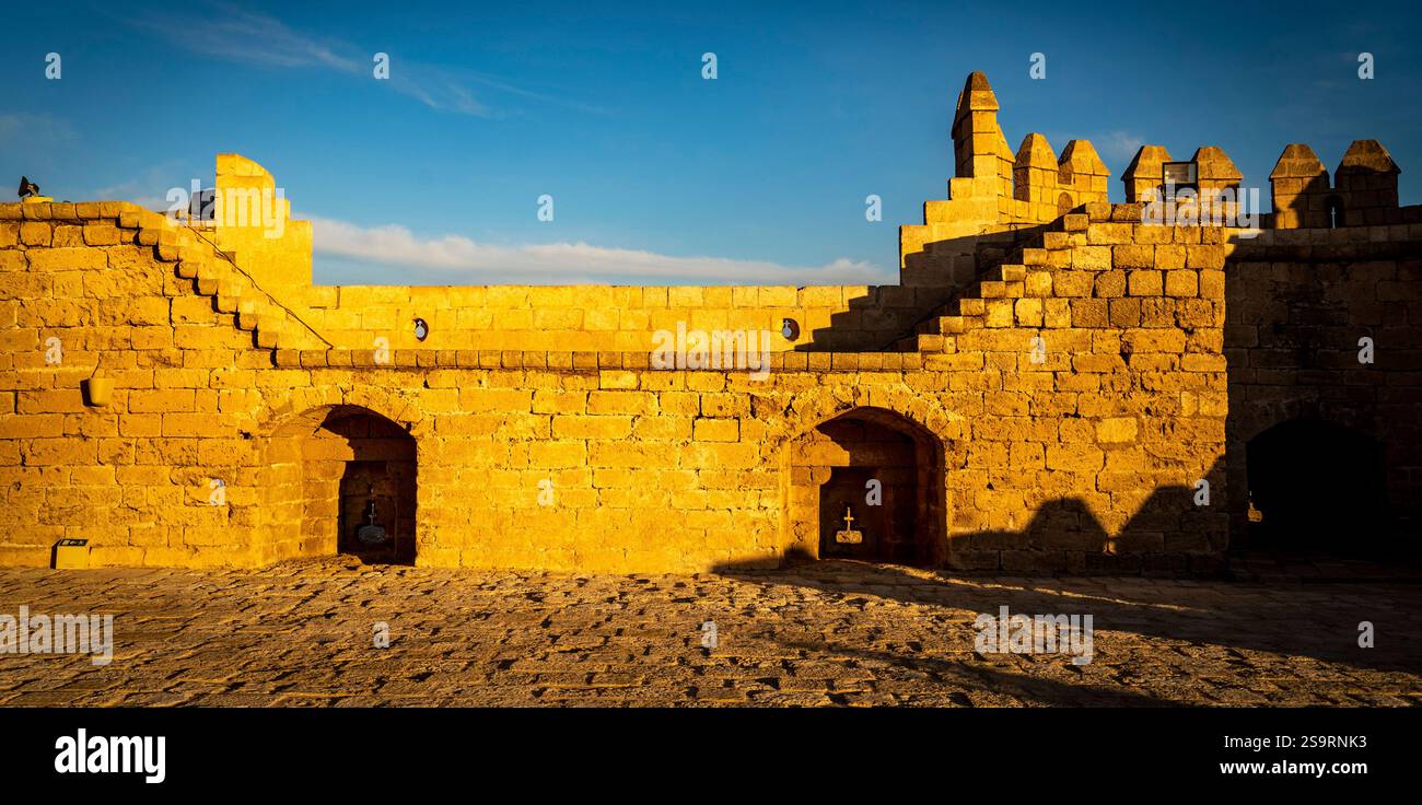 A historic stone fortress wall with arches and battlements under a ...