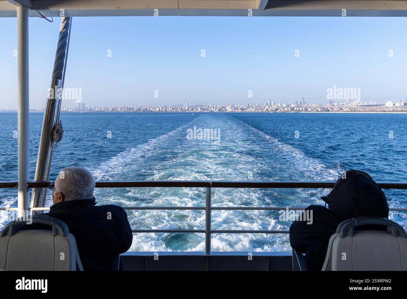 Passengers on a ferry enjoy the scenic Bosphorus view with Istanbul’s ...