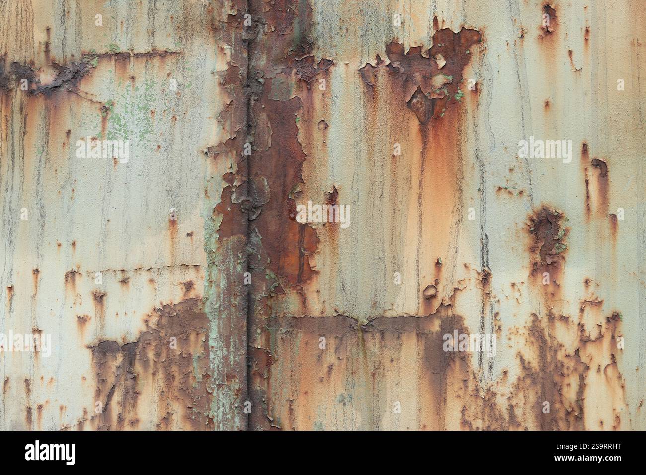 Old rusty metal surface with peeling paint and dirty streaks from rain ...