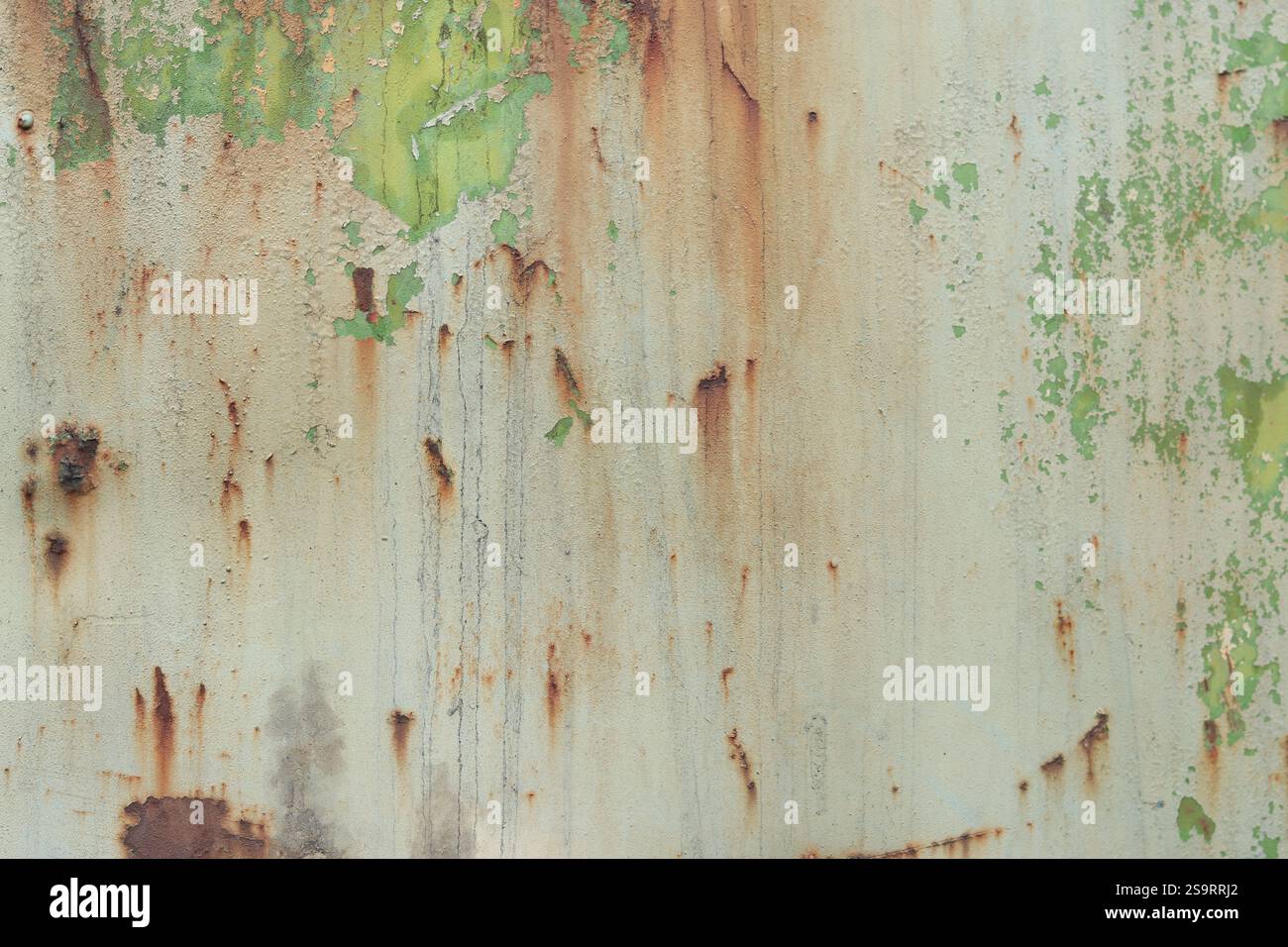 Old rusty metal surface with peeling paint and dirty streaks from rain ...