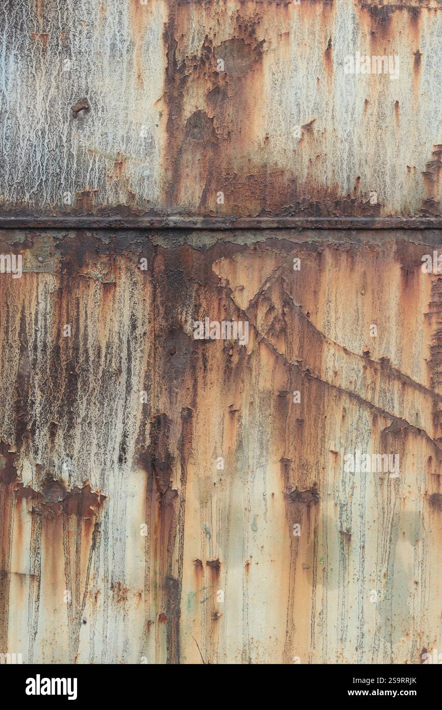Old rusty metal surface with peeling paint and dirty streaks from rain ...