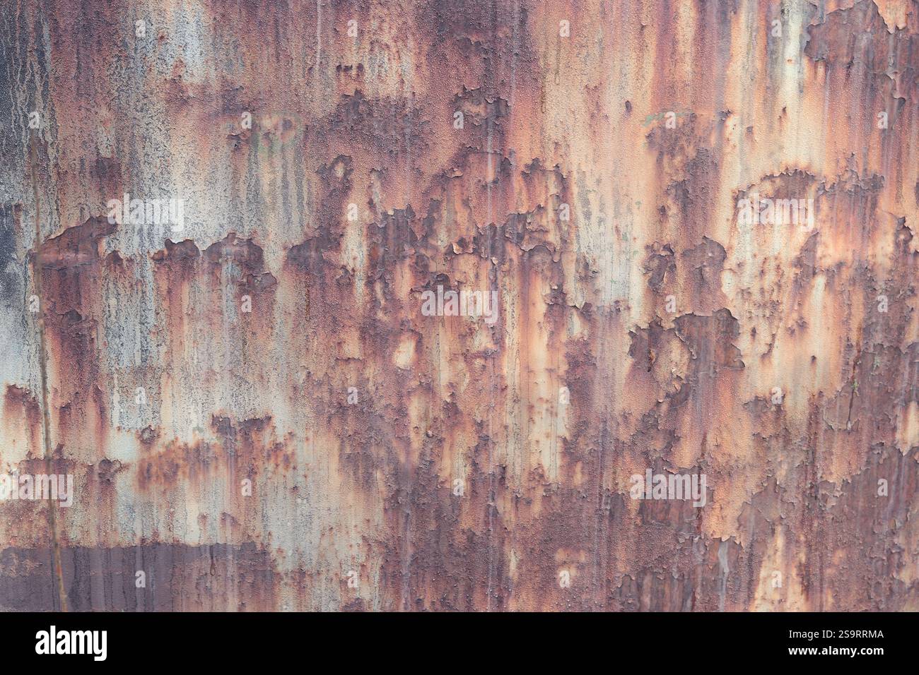 Old rusty metal surface with peeling paint and dirty streaks from rain ...