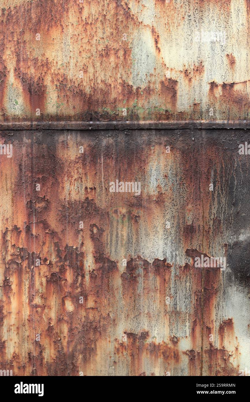 Old rusty metal surface with peeling paint and dirty streaks from rain ...