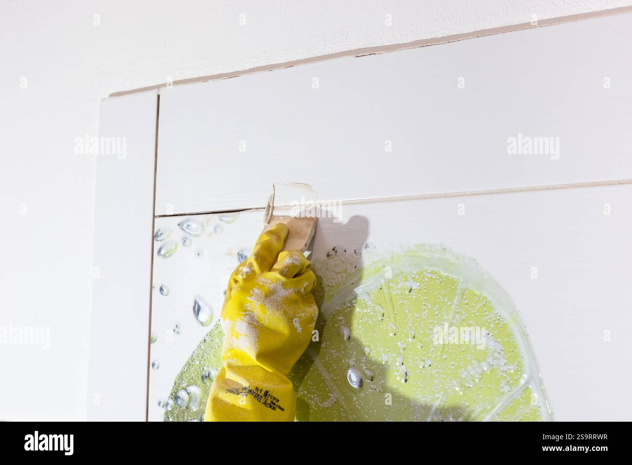 Laying ceramic tiles. The craftsman fills the tile joints with grout ...