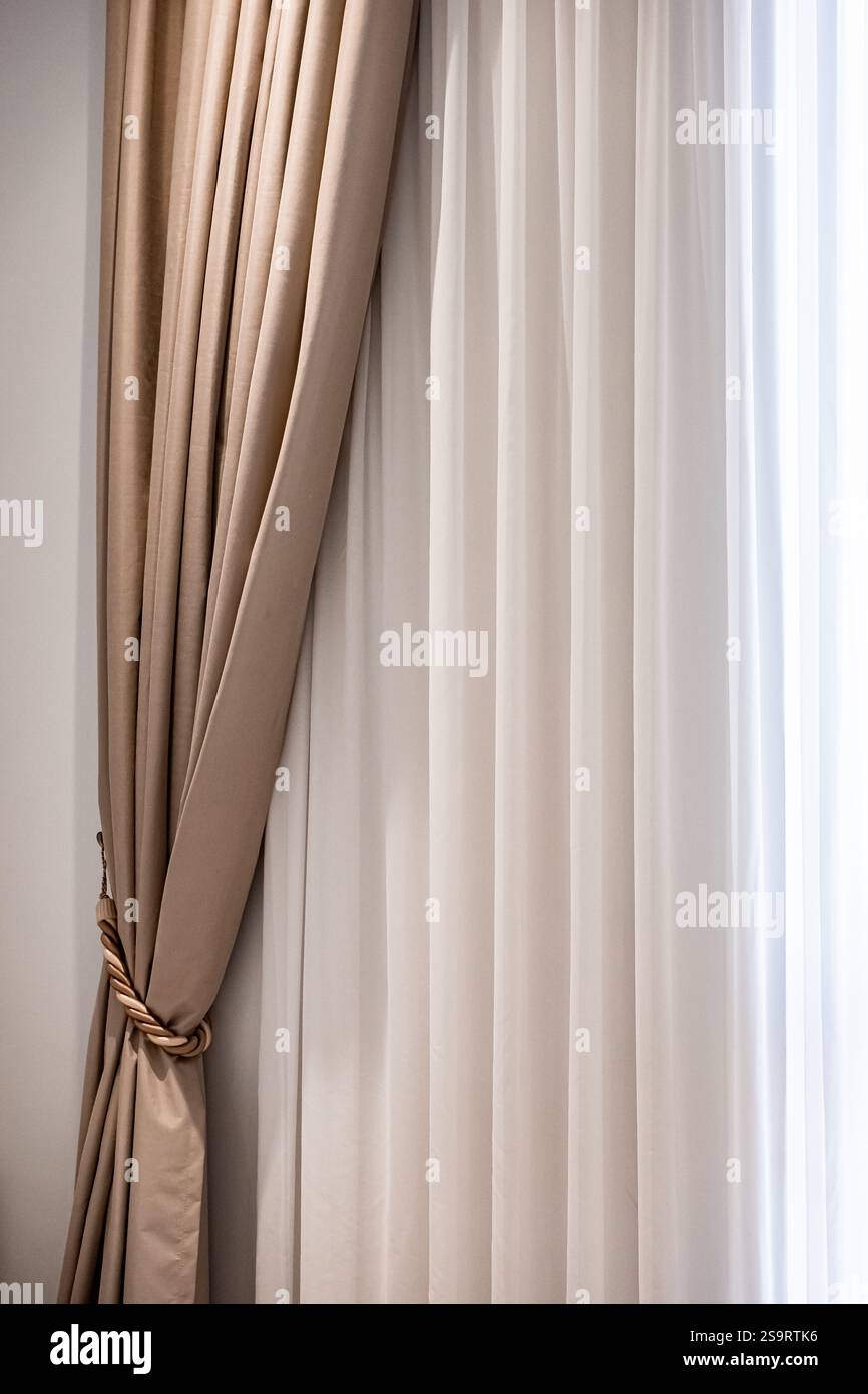 Cozy bedroom interior with light curtains. Close up view of Beige ...