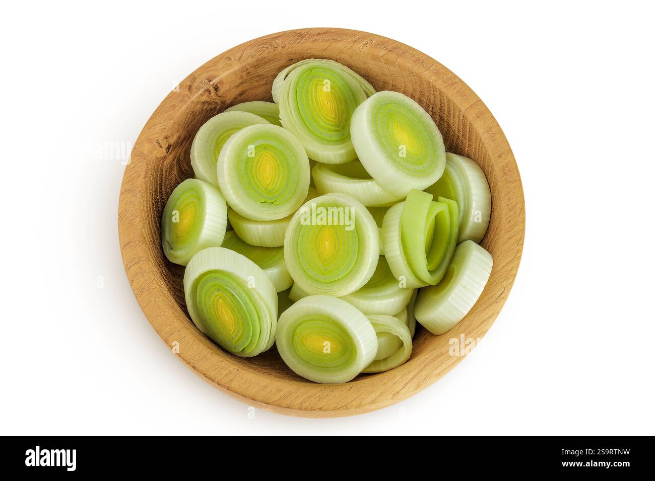sliced Leek vegetable in wooden bowl isolated on white background. Top ...