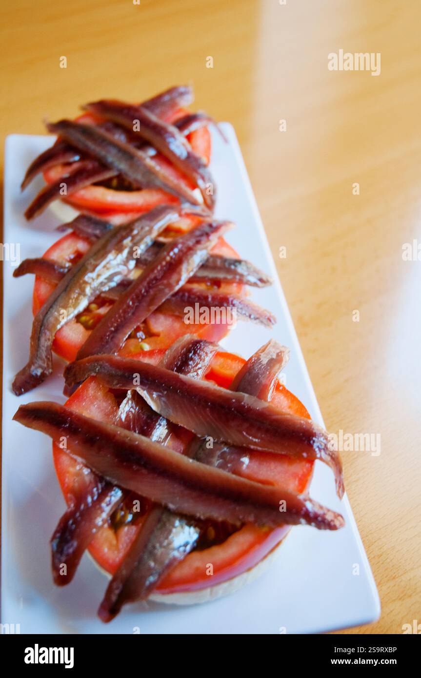 Anchovy fillets with sliced tomato. Spain Stock Photo - Alamy