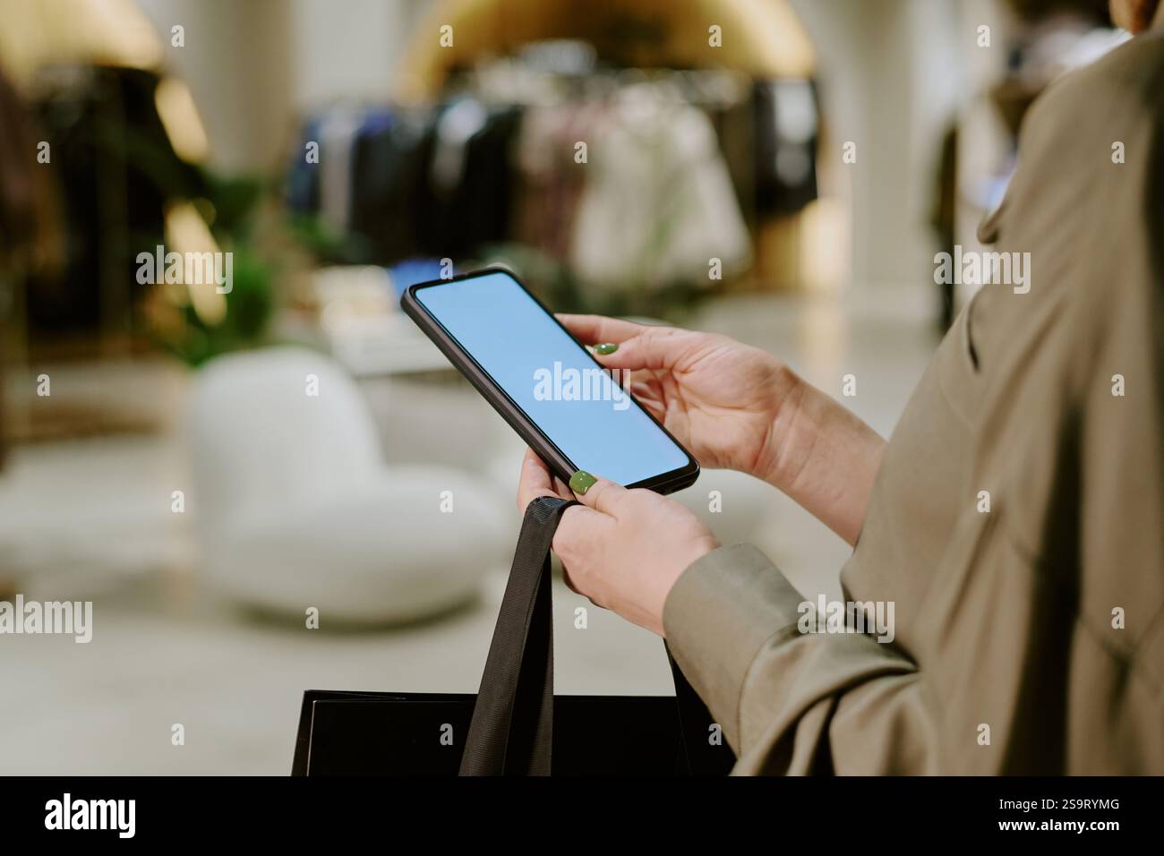 Medium close up black smartphone with white screen in unrecognizable ...