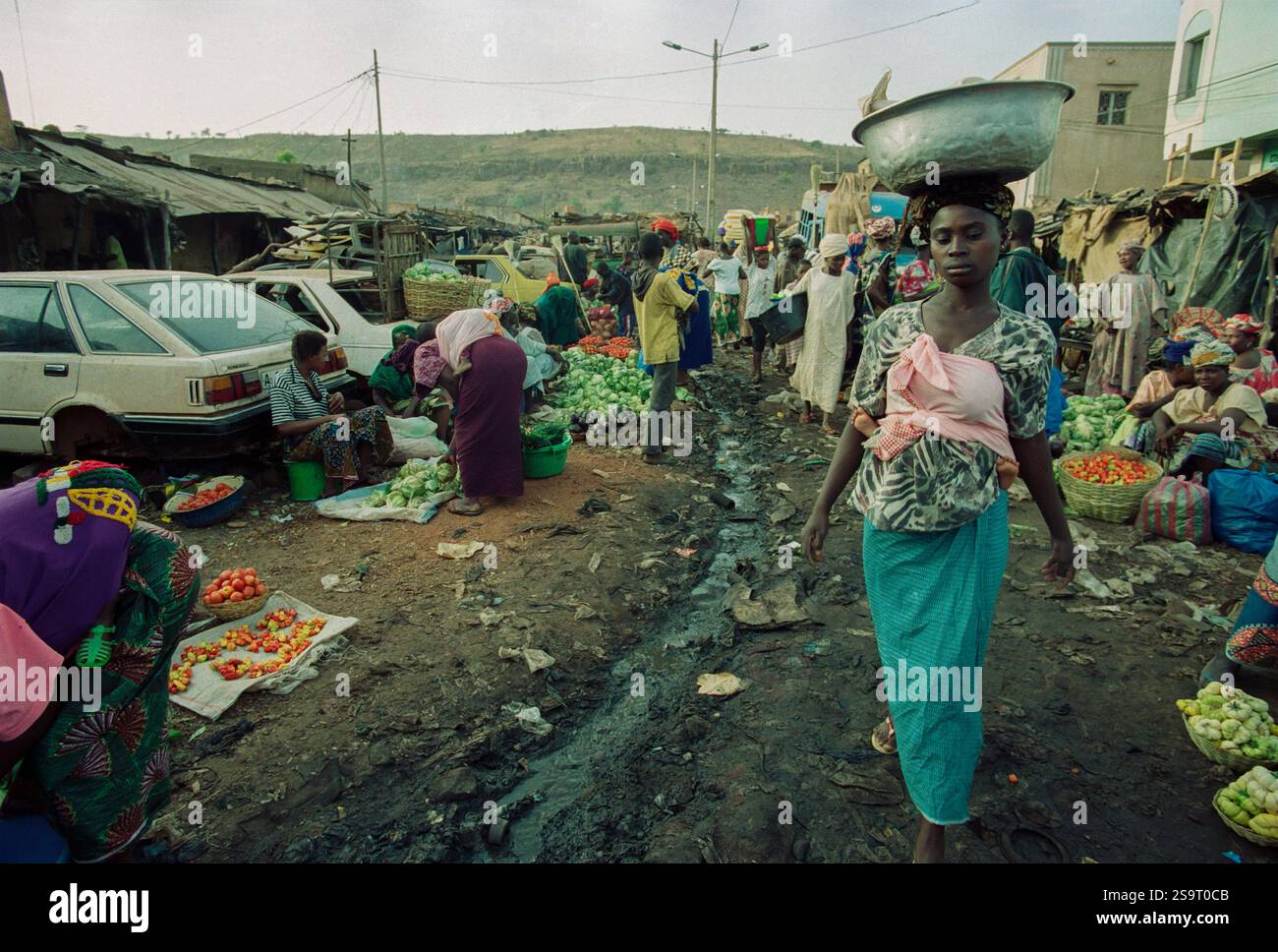Women carrying provisions in the slums of Bamako scattered throughout ...