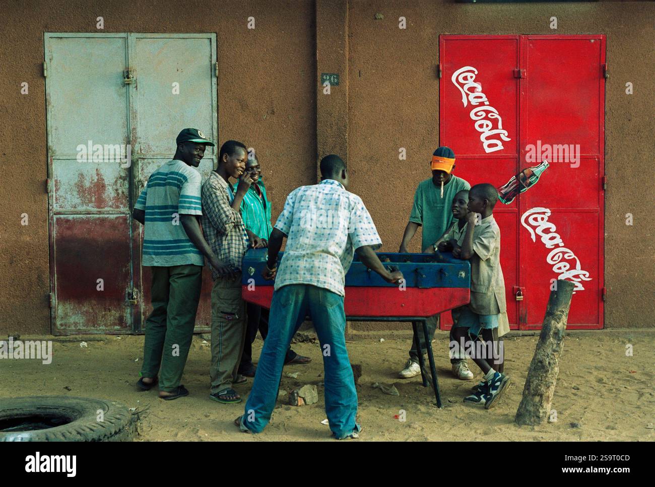Men playing table football in the slums of Bamako scattered throughout ...