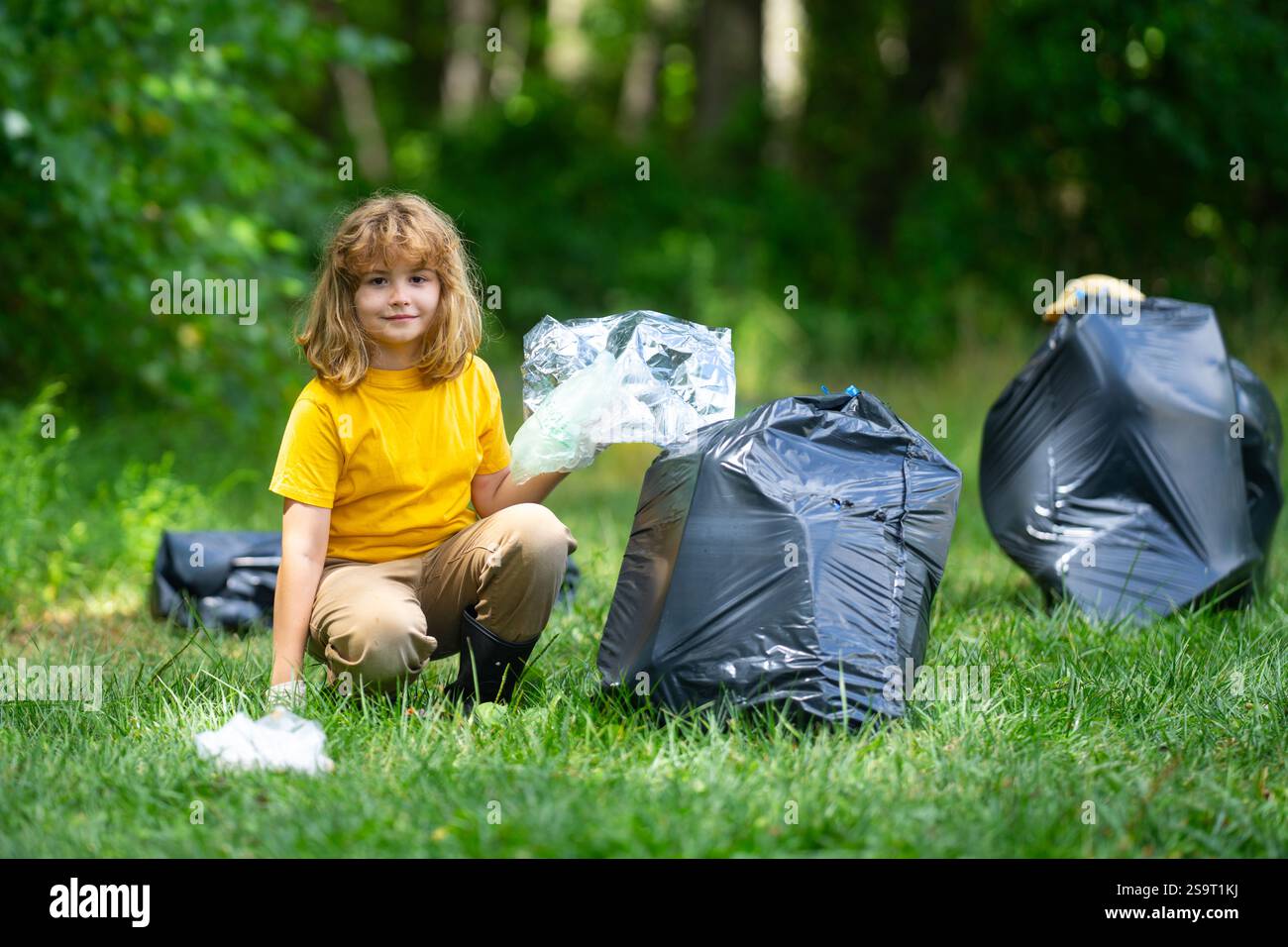 Kid in rubber gloves with trash bag clean up garbage on forest outdoor ...