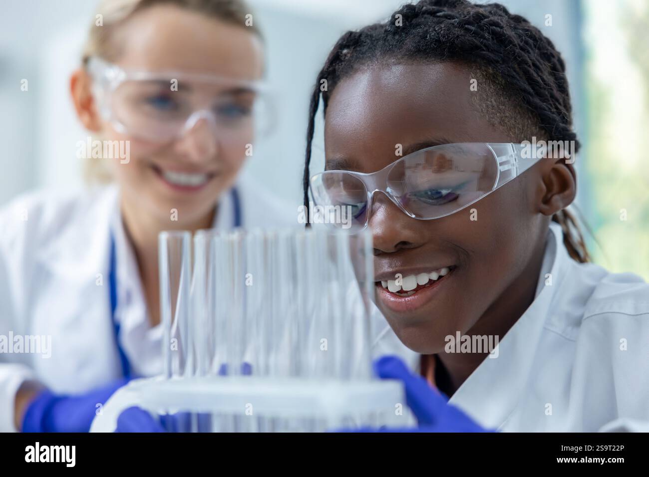 Women researchers conducting experiment on dna samples using tubes with ...