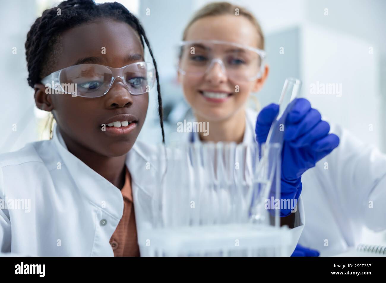 Females professional in clinic working with test tube conducting ...