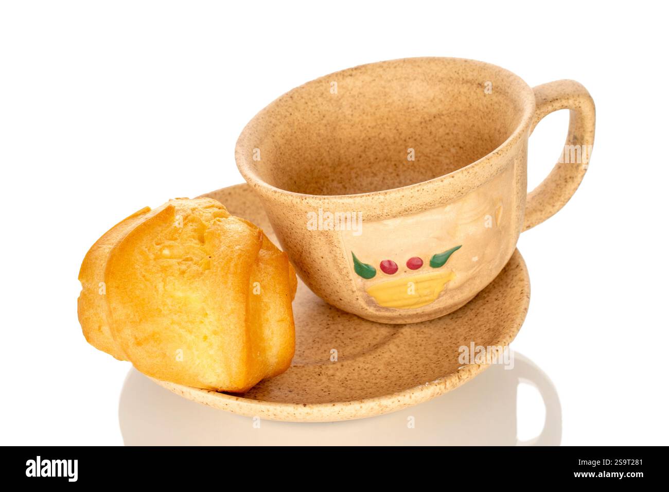 One eclair with ceramic cup on saucer, close-up, isolated on white ...