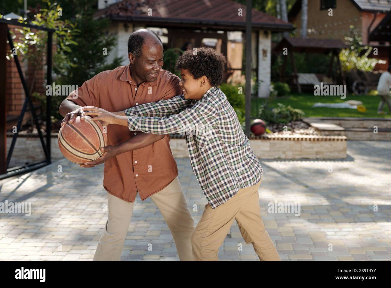 African American Father Teaching Son Playing Basketball Stock Photo - Alamy