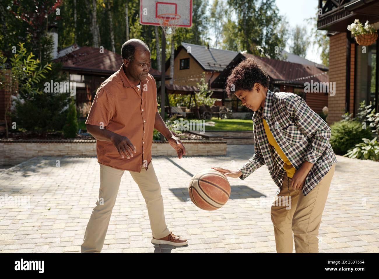 Playing Basketball Outdoors in Residential Area Stock Photo - Alamy