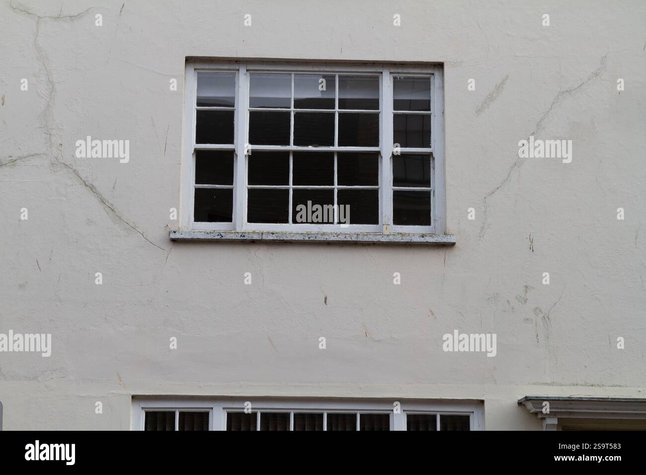 Cracked render around the window of an old building in Kings Lynn Stock ...
