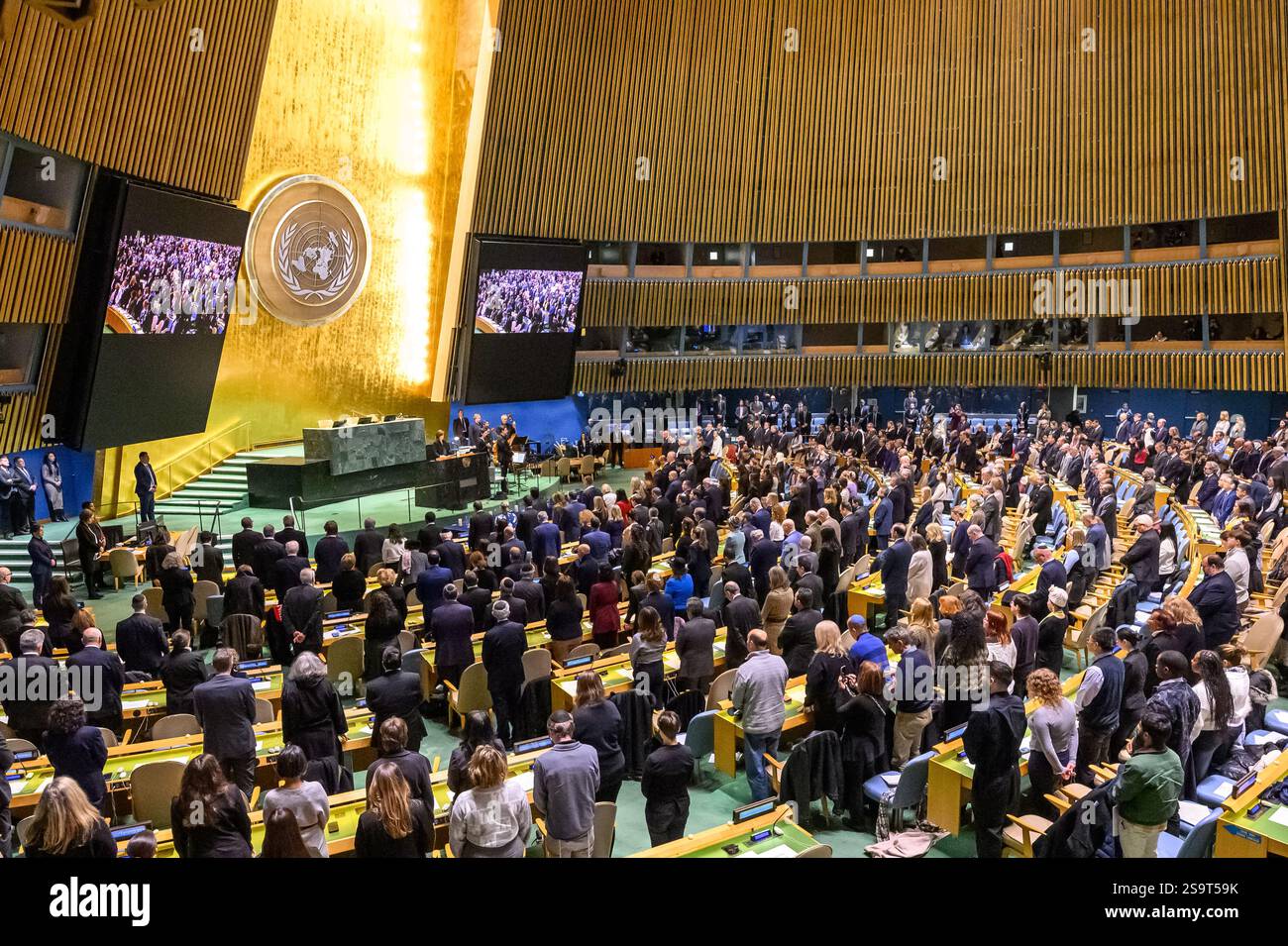 New York, USA. 27th Jan, 2025. Delegates stand in silence at the United ...