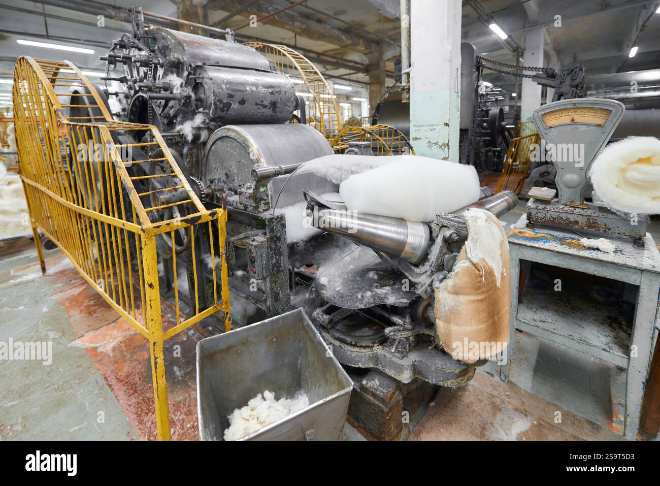 Intricate vintage carding machine showcased in a bustling textile ...