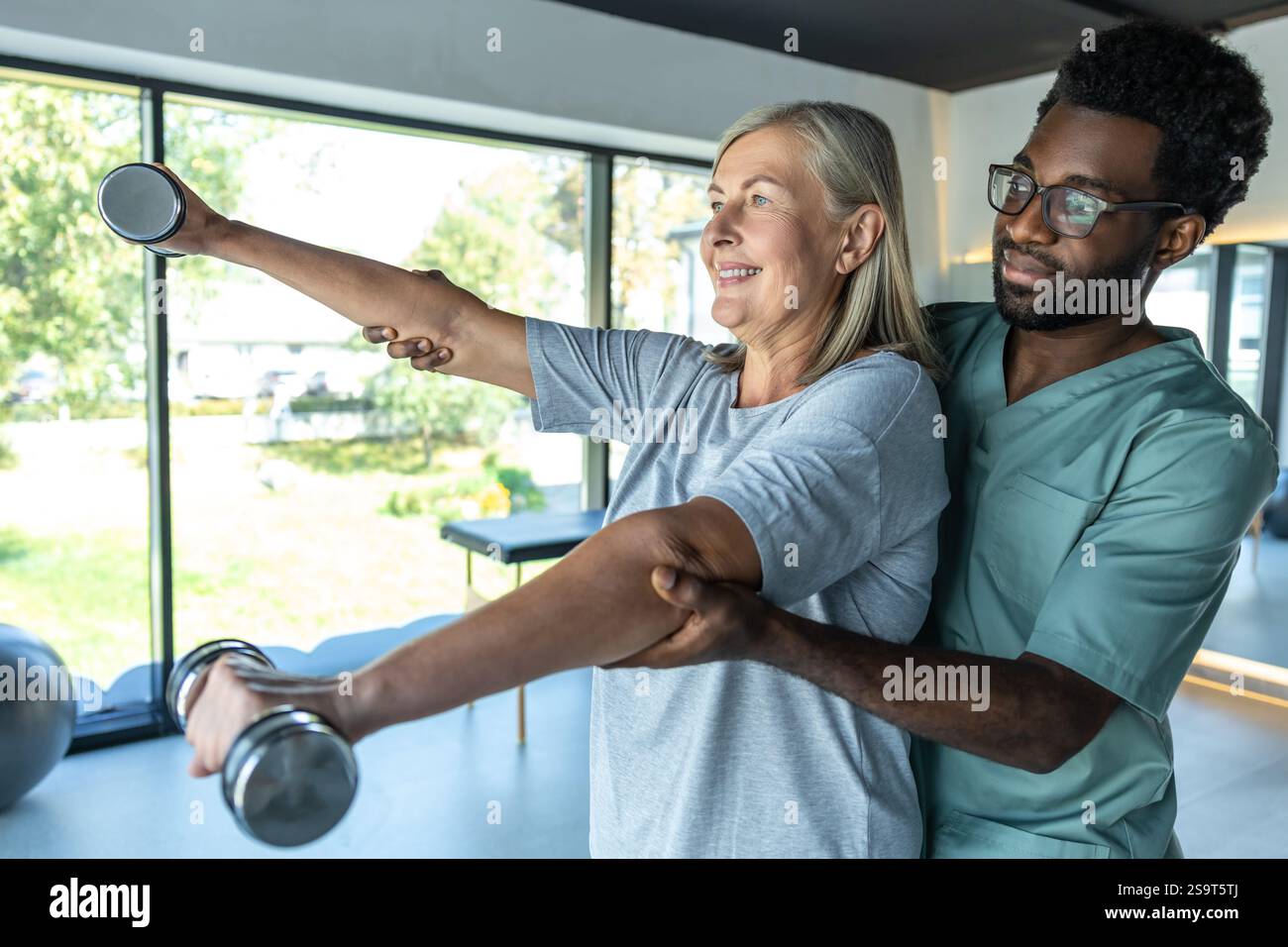 Medic man providing rehabilitation treatment and consulting patients ...