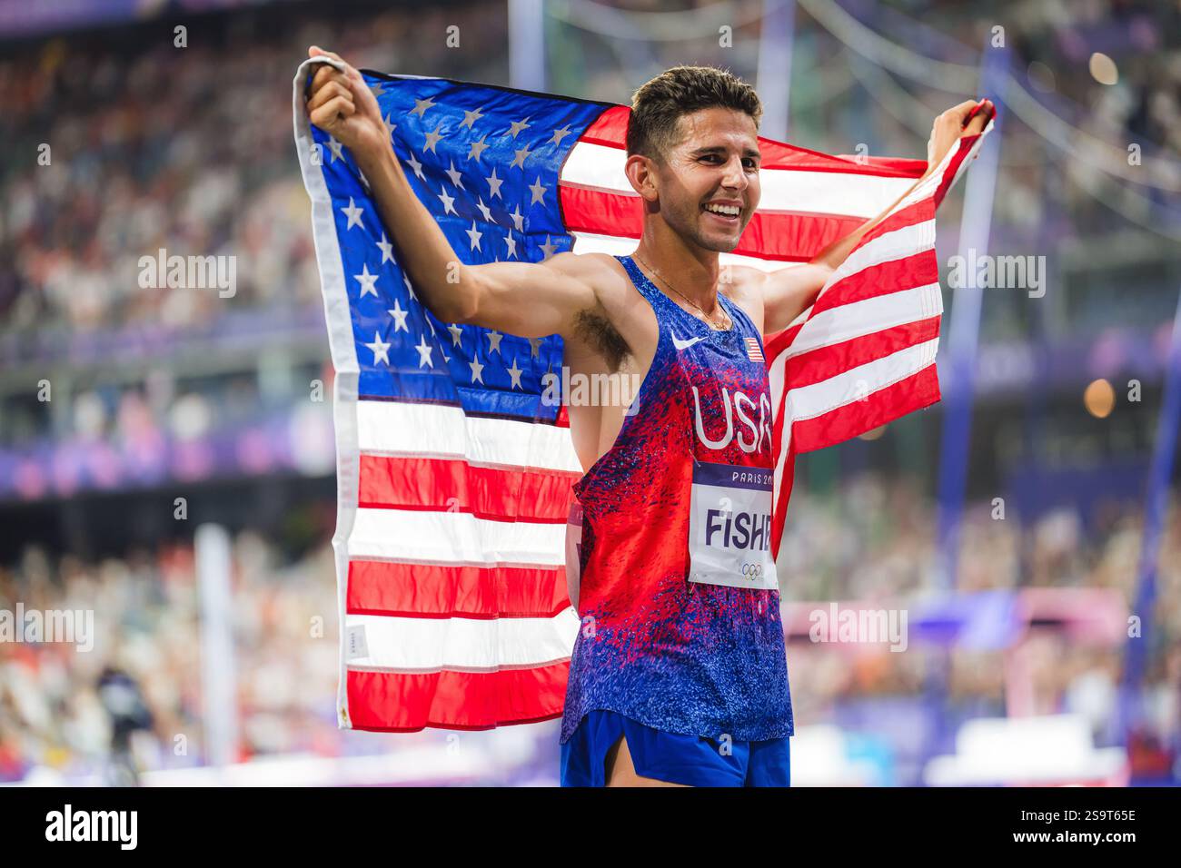 Grant Fisher celebrating her medal with her country's flag at the Paris ...