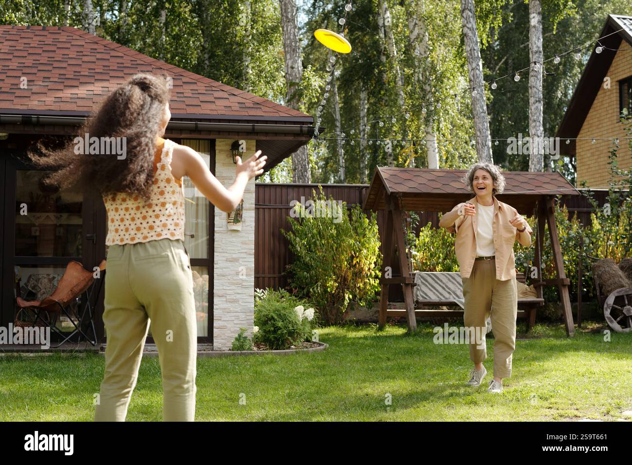 Playing Frisbee with Joy in Backyard Garden Stock Photo - Alamy