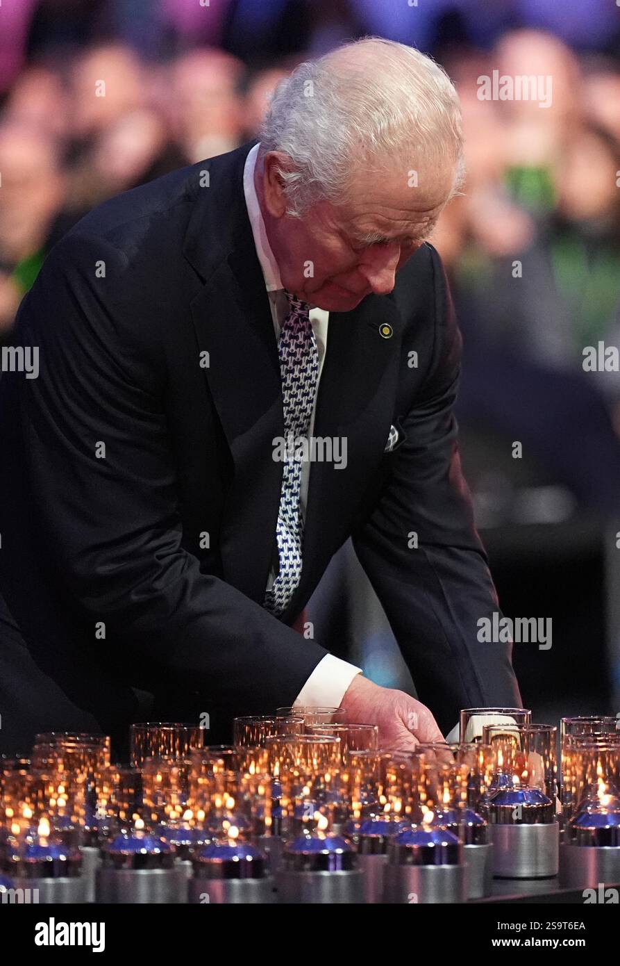 King Charles III lays a candle during commemorations at Auschwitz ...