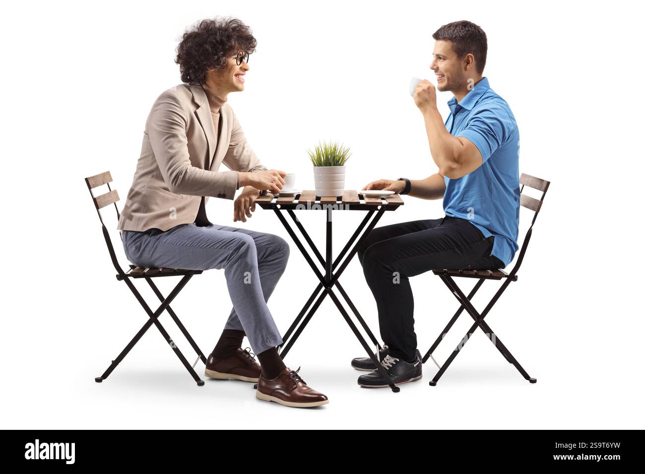 Two young men having a coffee at a cafe isolated on white background ...