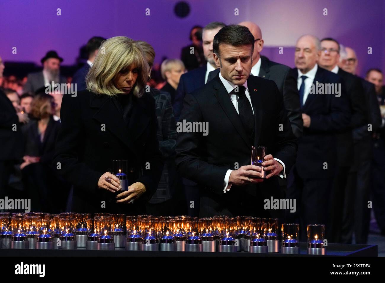 French President Emmanuel Macron, his wife Brigitte place lit candles ...
