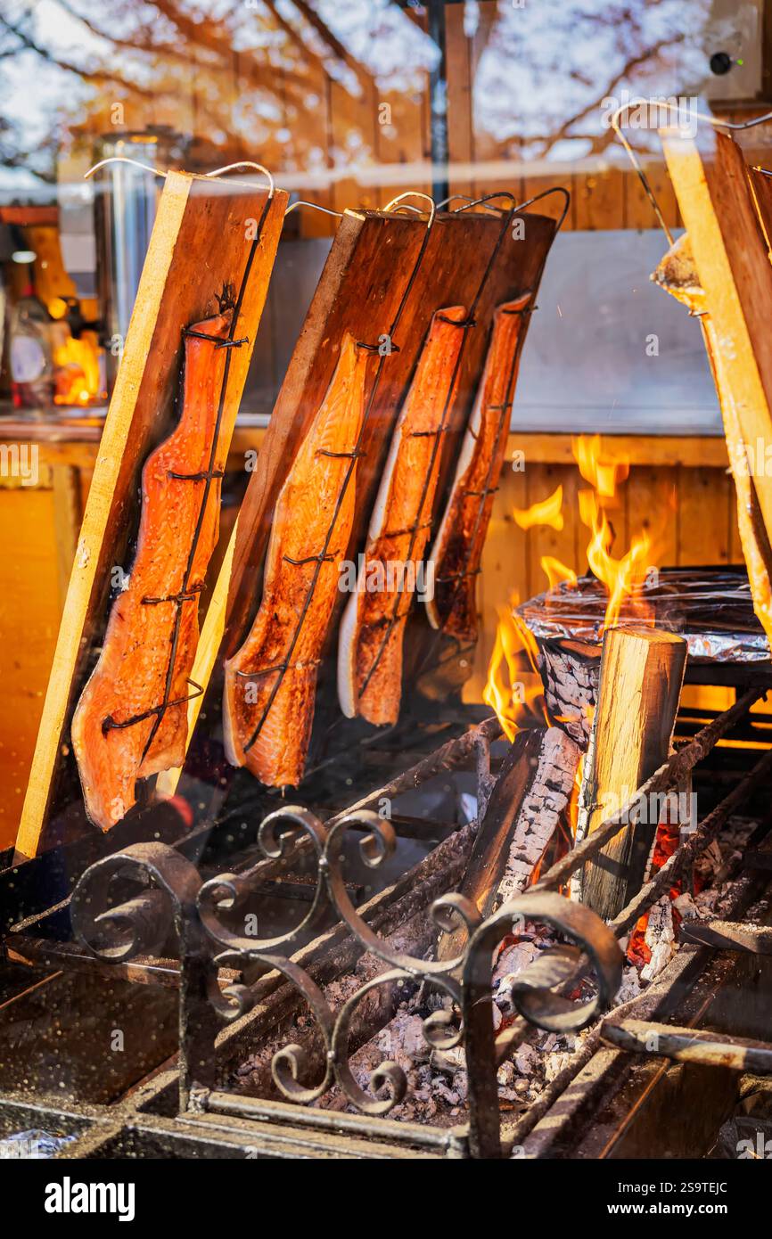 Salmon fillets roasting over open fire, outdoor market. Concept of ...