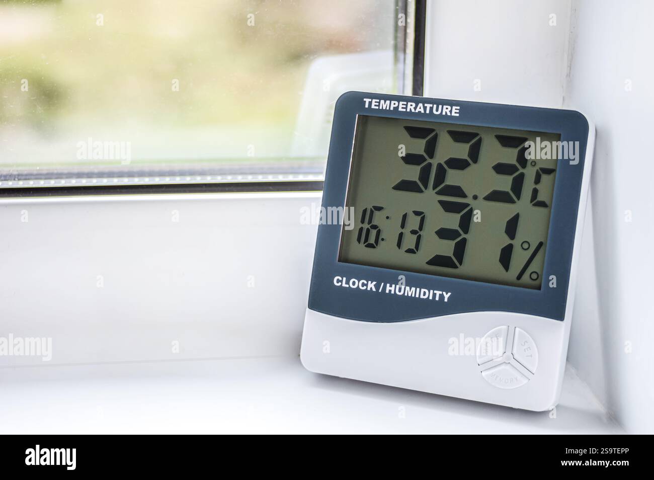 Digital thermometer displaying temperature, humidity, and time ...