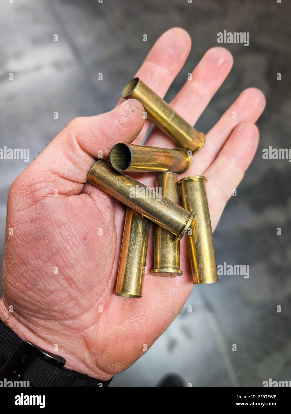 Large shells from a Magnum revolver in a man's hand, vertical photo ...