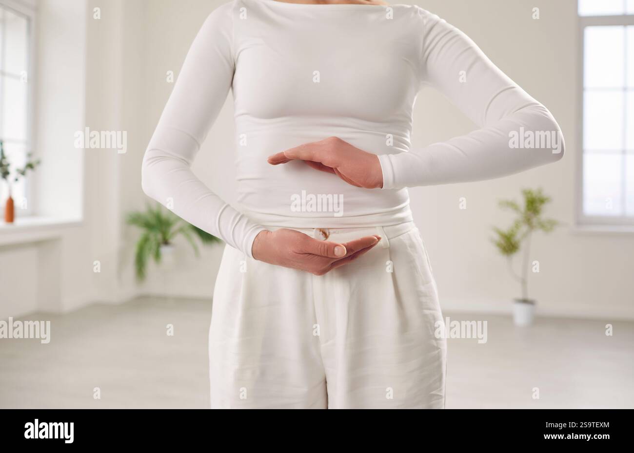 Woman Shapes Circle On Belly With Hands Stock Photo - Alamy