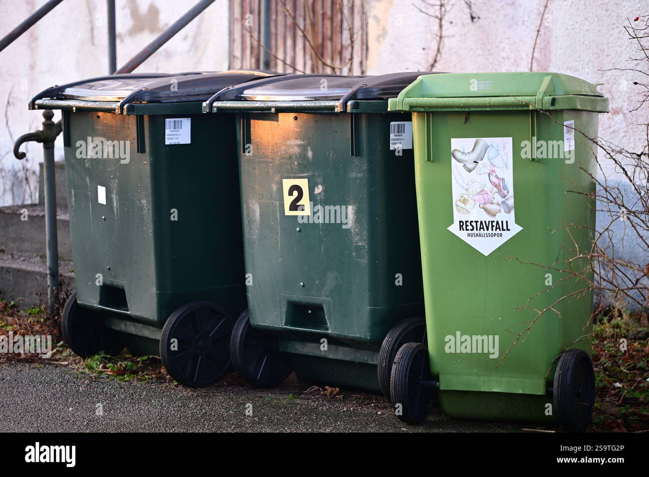 Skånes-Fagerhult, Skåne, Sweden. January 15 2025. Line of trash cans on ...
