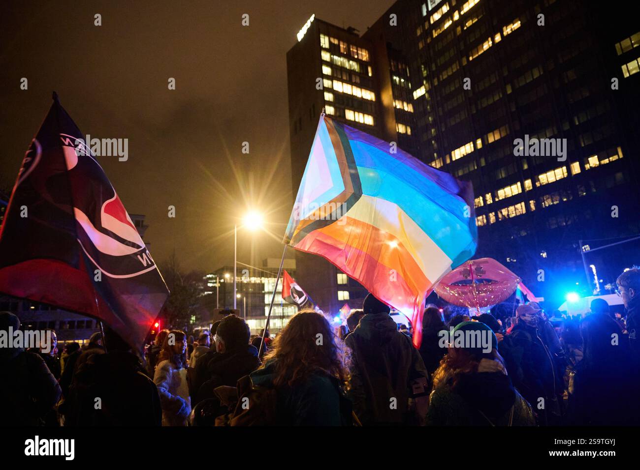27 January 2025, Berlin: An LGBTQIA+ flag flies in front of the Axel ...
