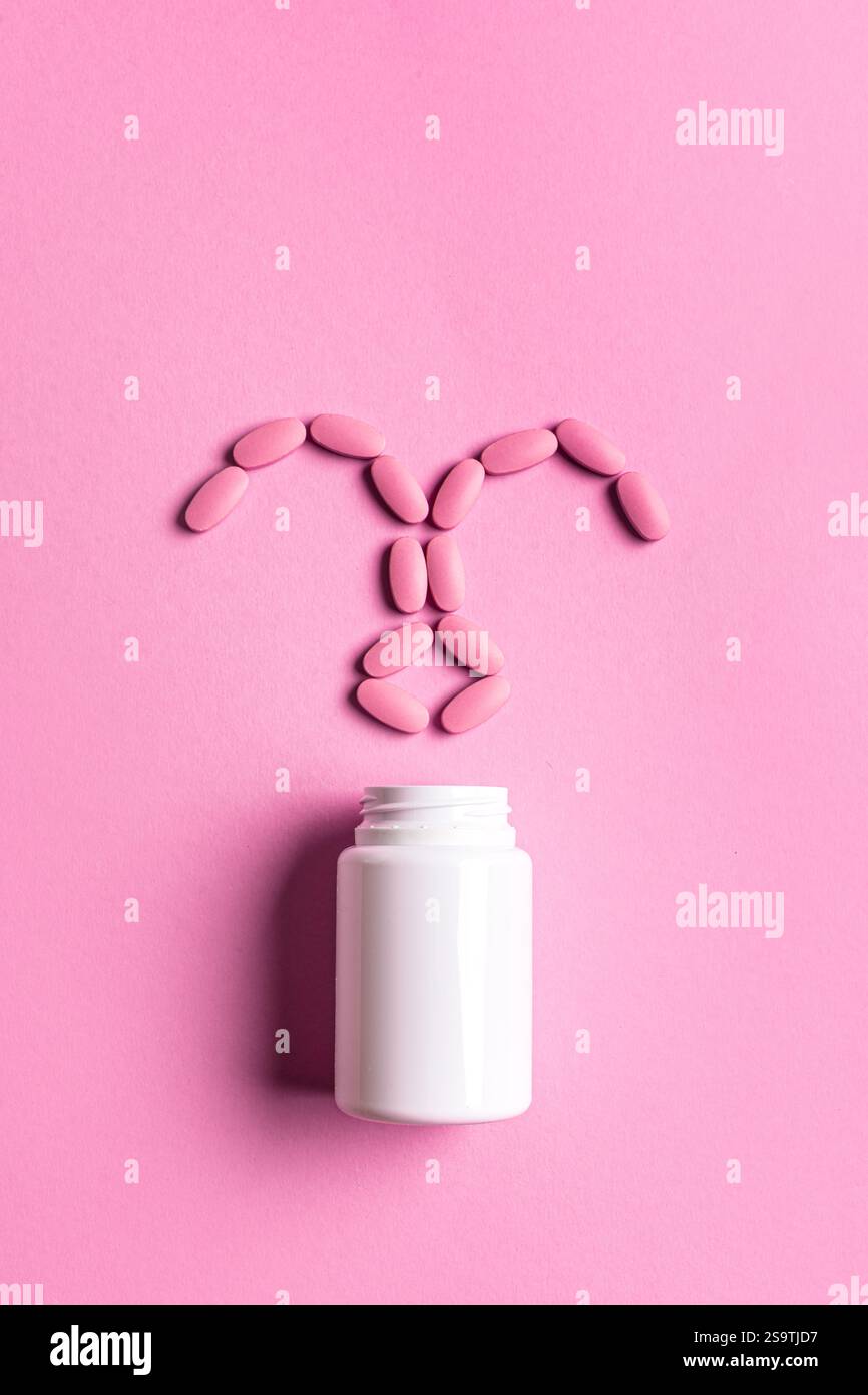 Uterus made of pink pills, minimal concept of female health on pink ...